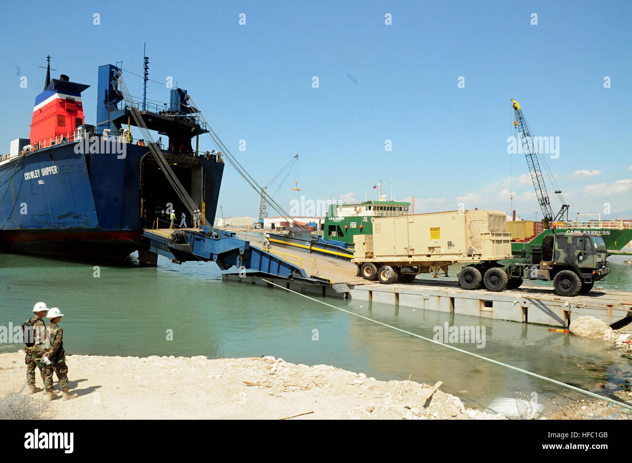 Service members conducting joint logistics over the shore operations at ...