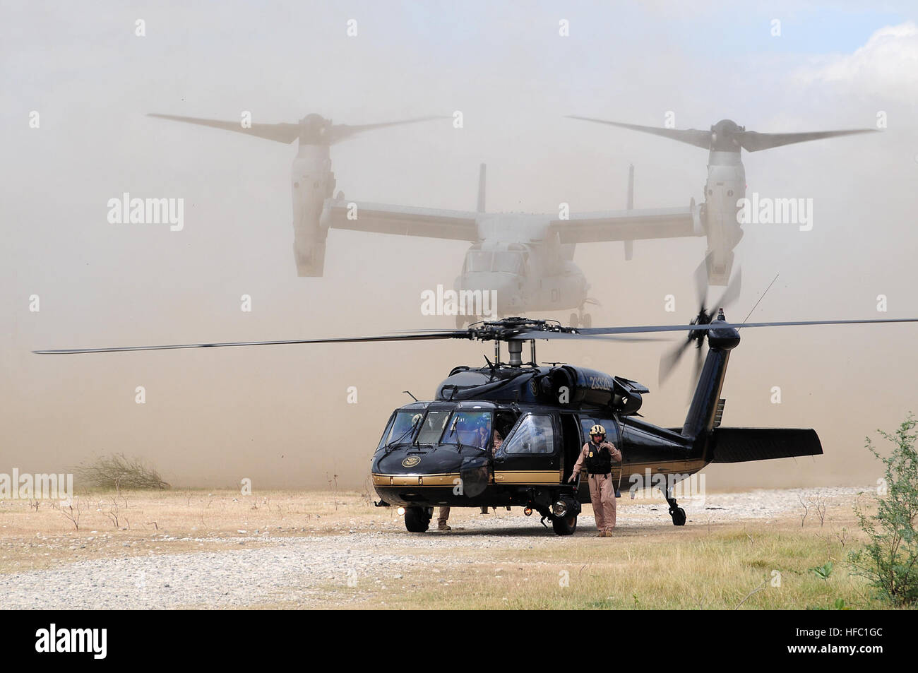 A U.S. Customs and Border Patrol helicopter awaits passengers as a Navy ...