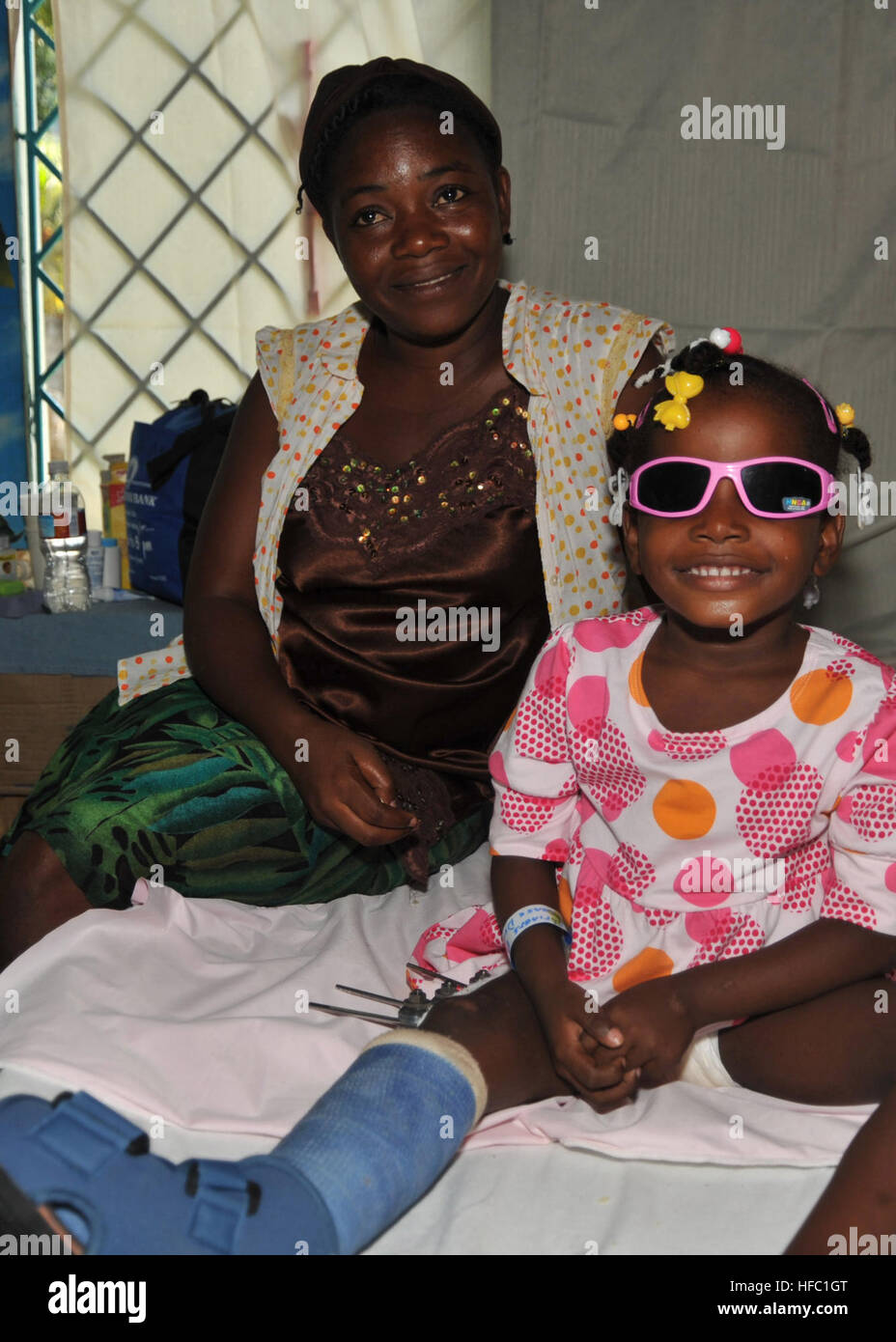 A young girl recovers from her leg injuries at the Milot hospital ...