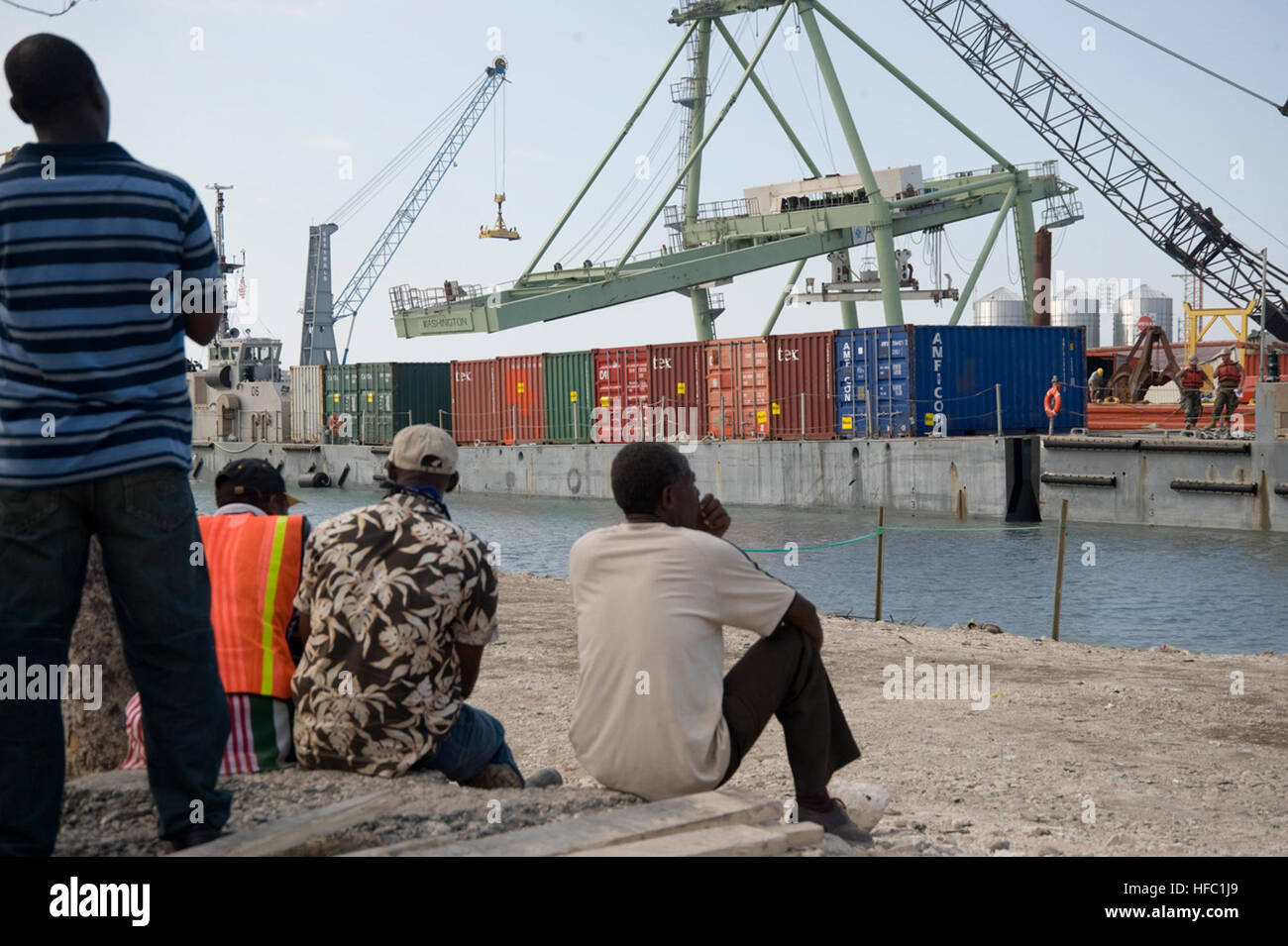 Haitians watch as members of Amphibious Construction Battalion Two ...