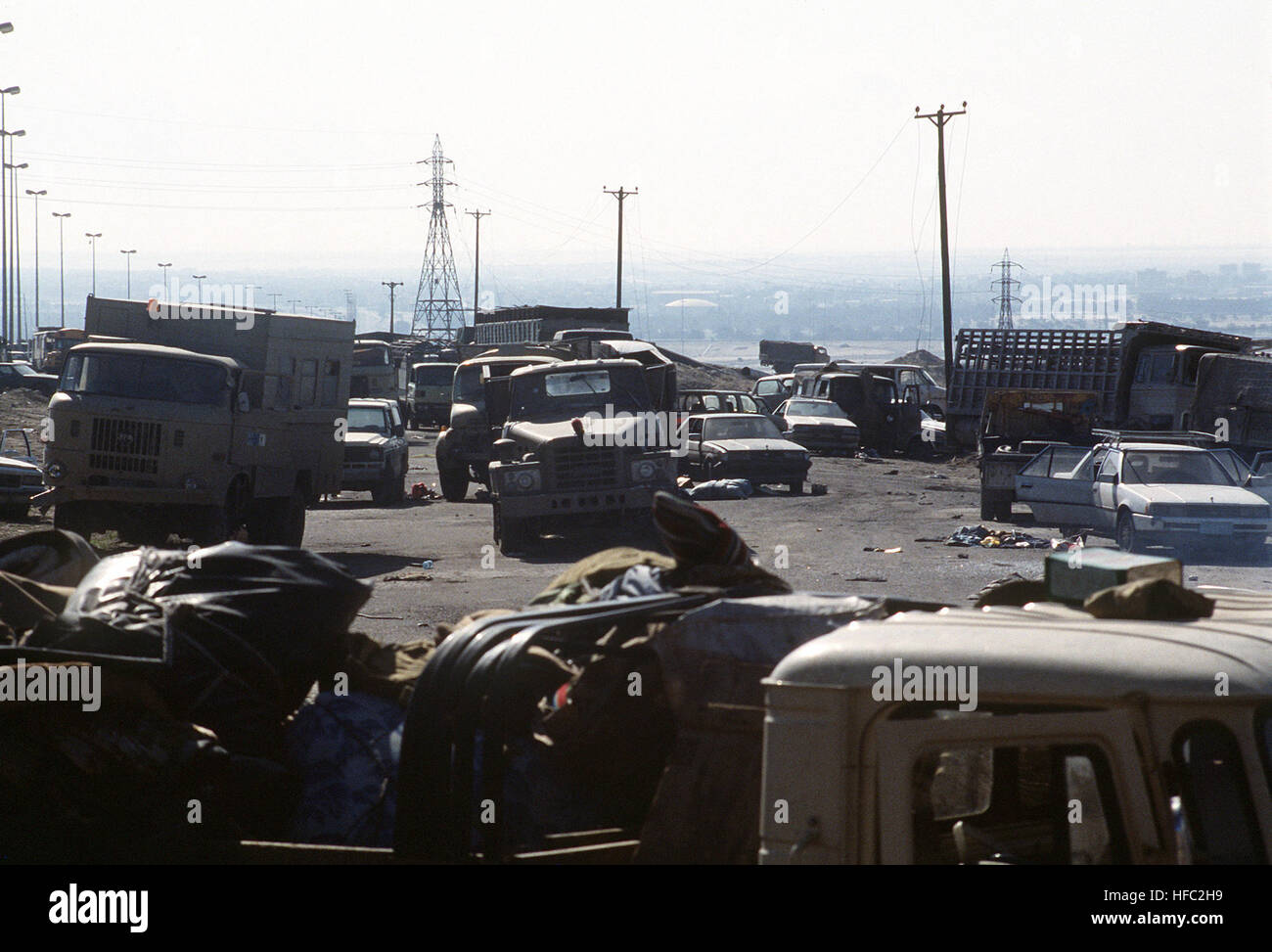 Abandoned cars and trucks clog the road leading out of Kuwait City ...