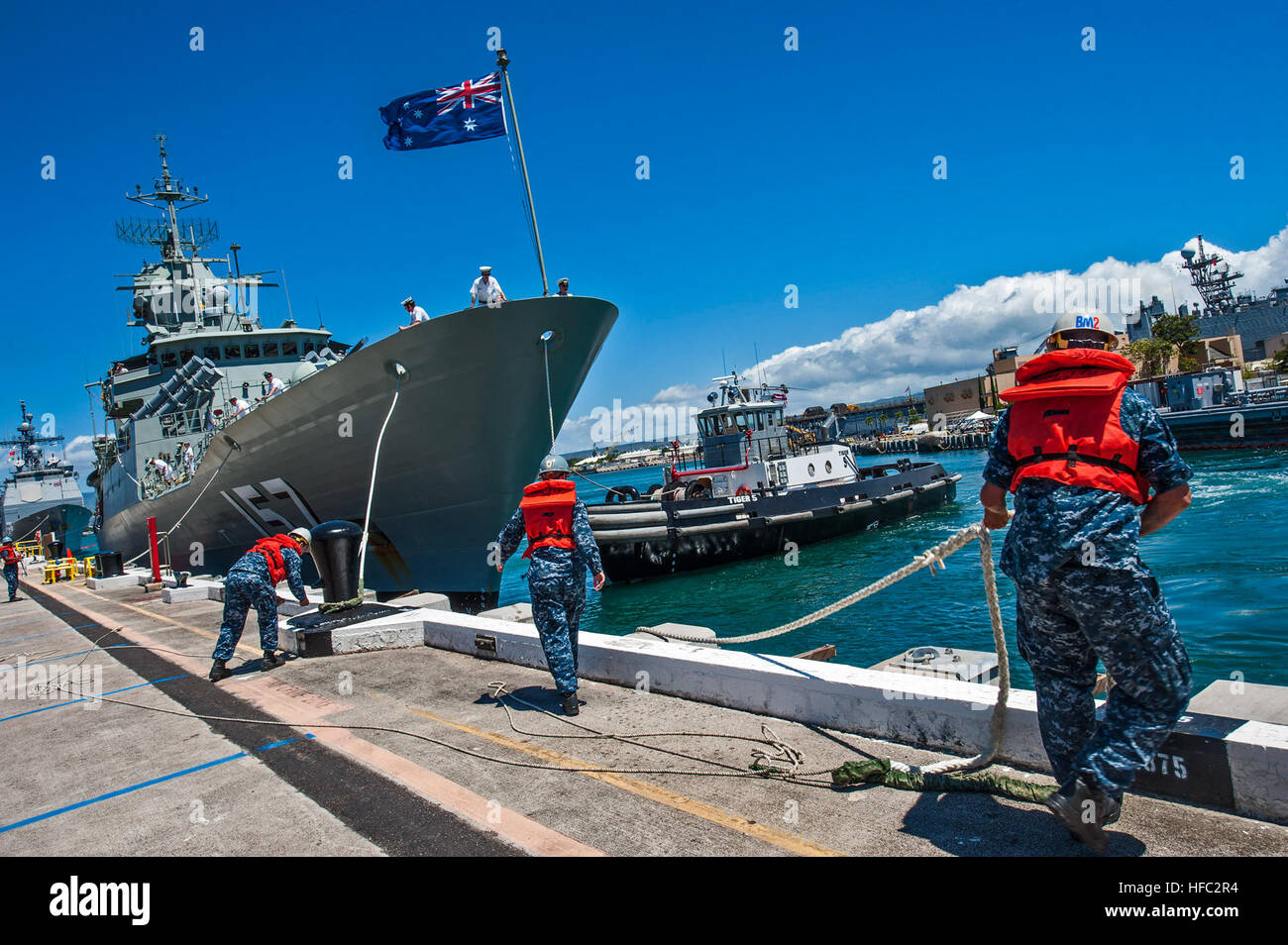 U.S. sailors heave in mooring lines as the Royal Australian Navy ...