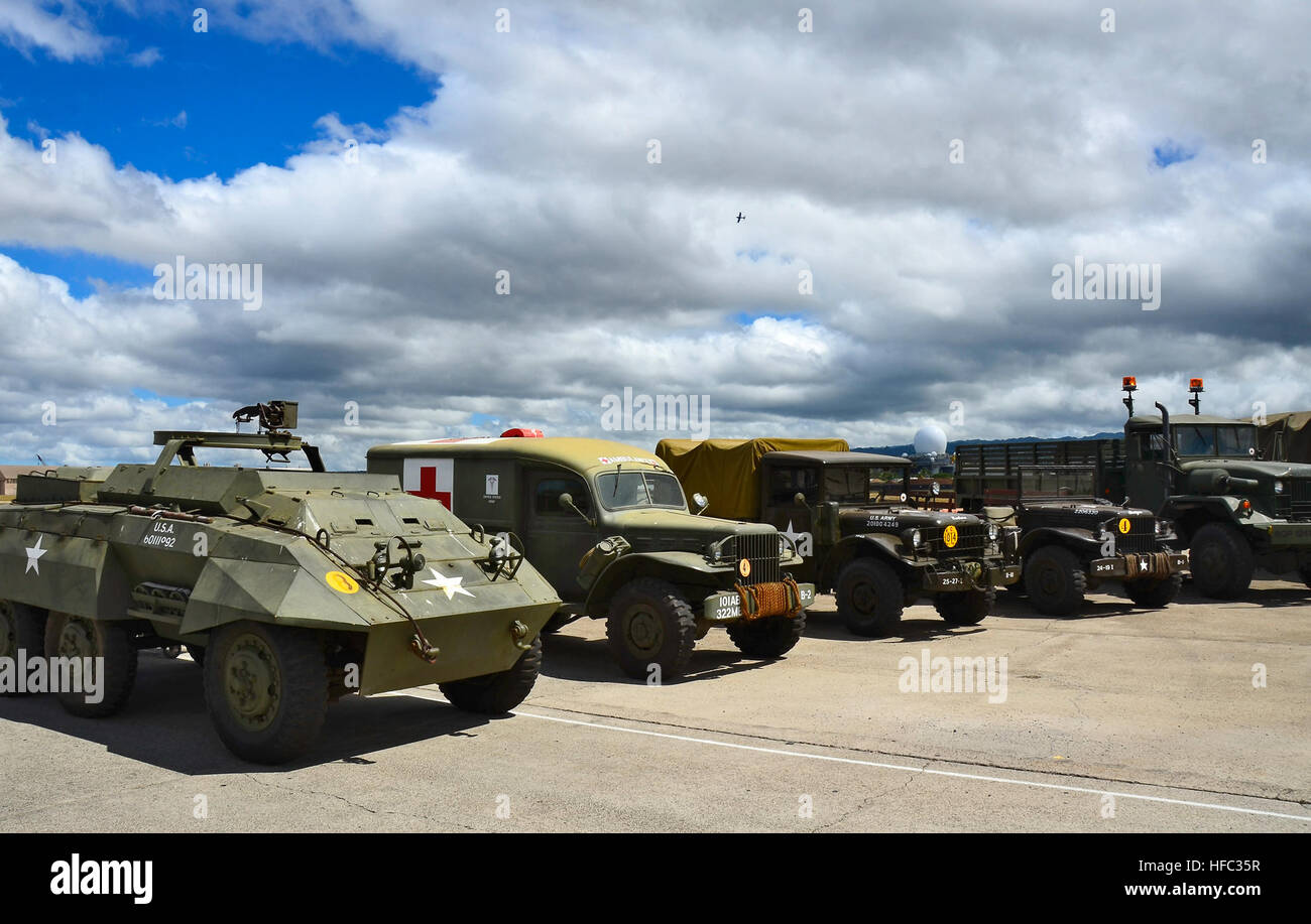 A U.S. Army M20 armored car, left, sits in a line with other vehicles ...