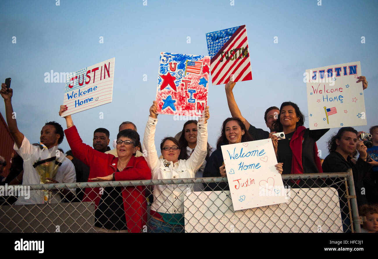 The family members and friends of U.S. sailors display welcome home ...