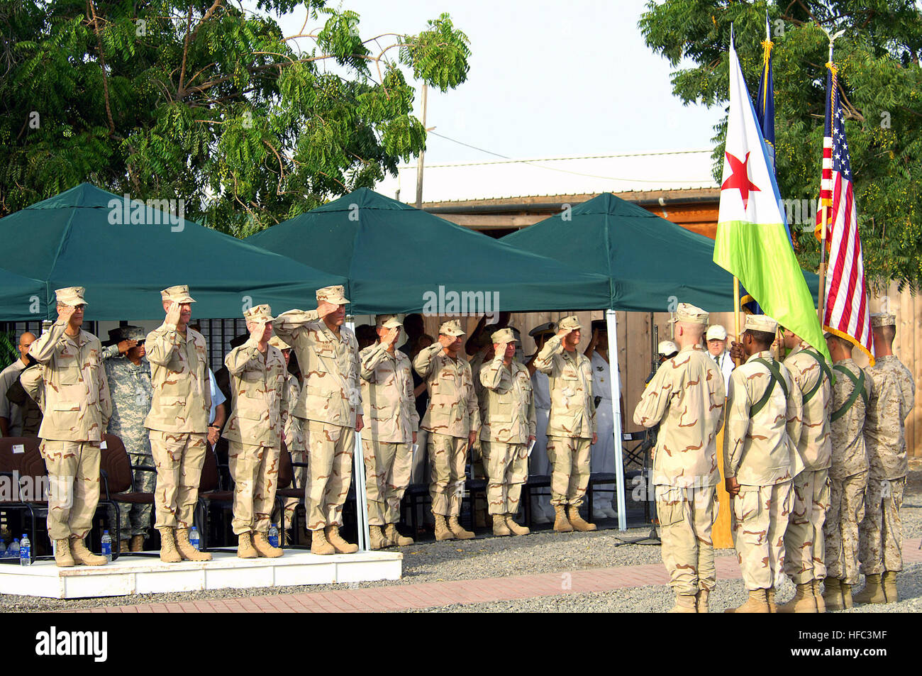 Members of the official party renders a salute to the color guard as it ...