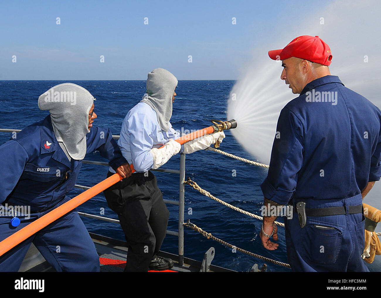 Damage controlman Petty Officer 1st Class Jeffery Parker supervises ...