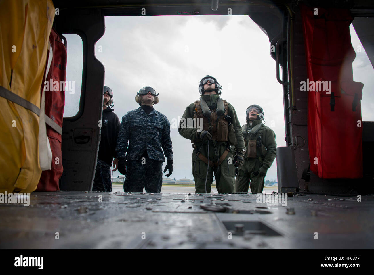 Sailors of Helicopter Sea Combat Squadron (HSC) 25, watch as the main ...