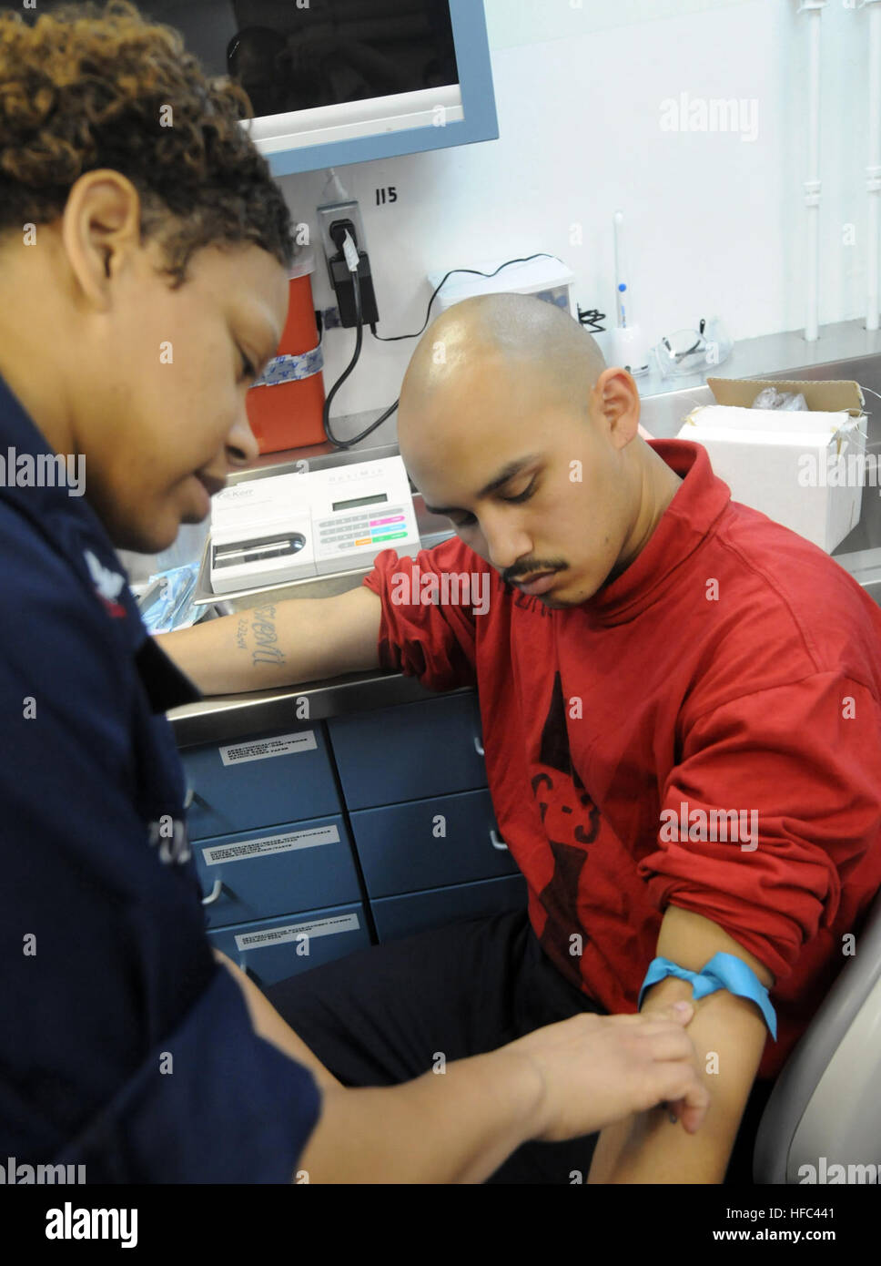 Petty Officer 2nd Class Delita Tolbert, hospital corpsman, takes a ...