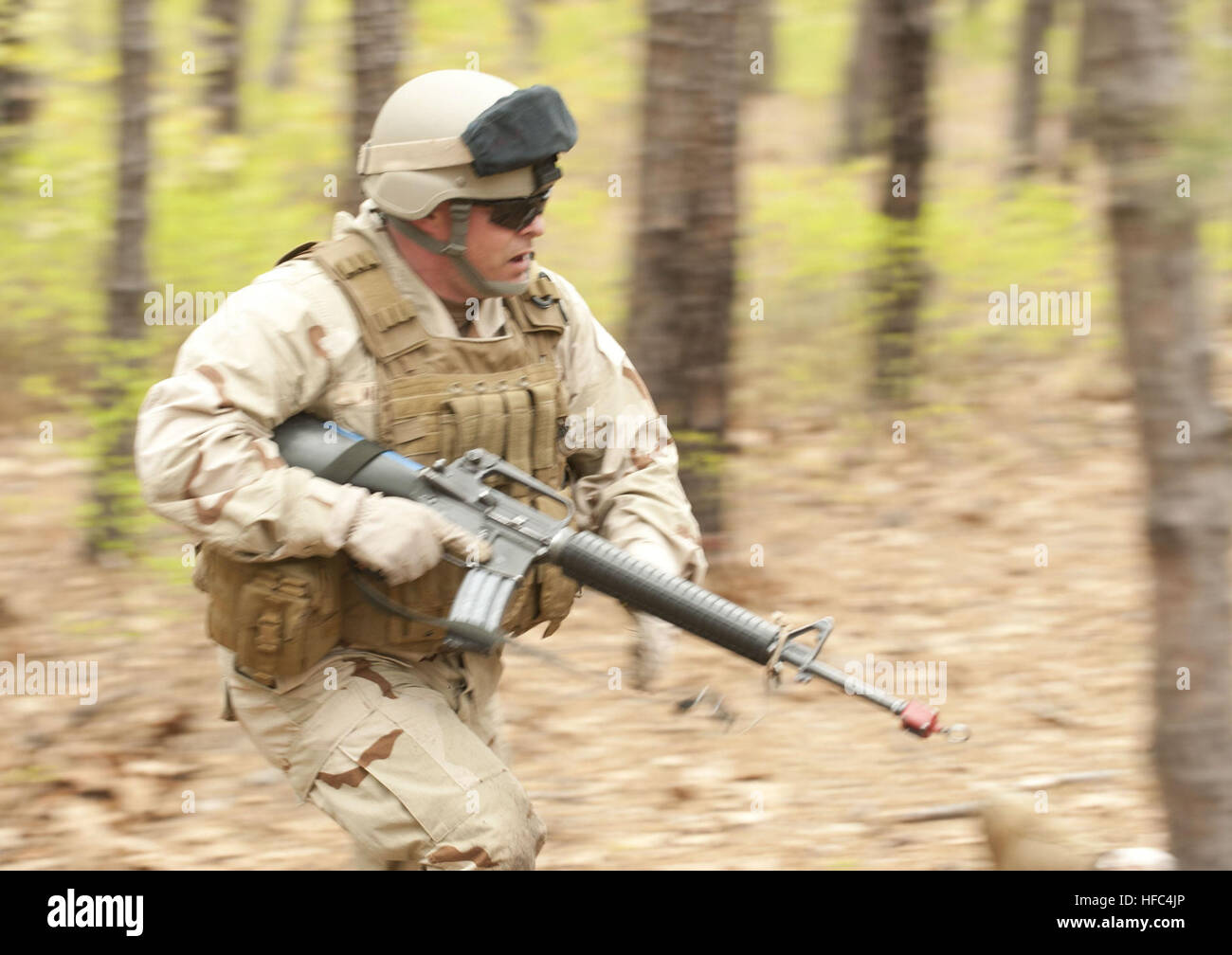 U.S. Coast Guard Lt. j.g. runs for cover during an Army Warrior ...