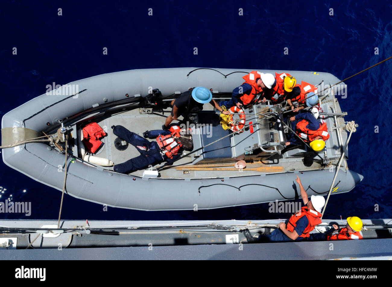 Sailors assigned to the amphibious command ship USS Blue Ridge hoist a ...