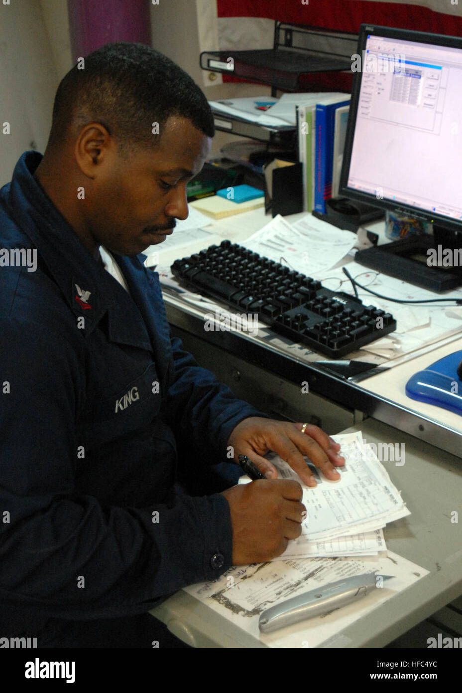 Storekeeper Petty Officer 2nd Class Christopher King logs supply ...