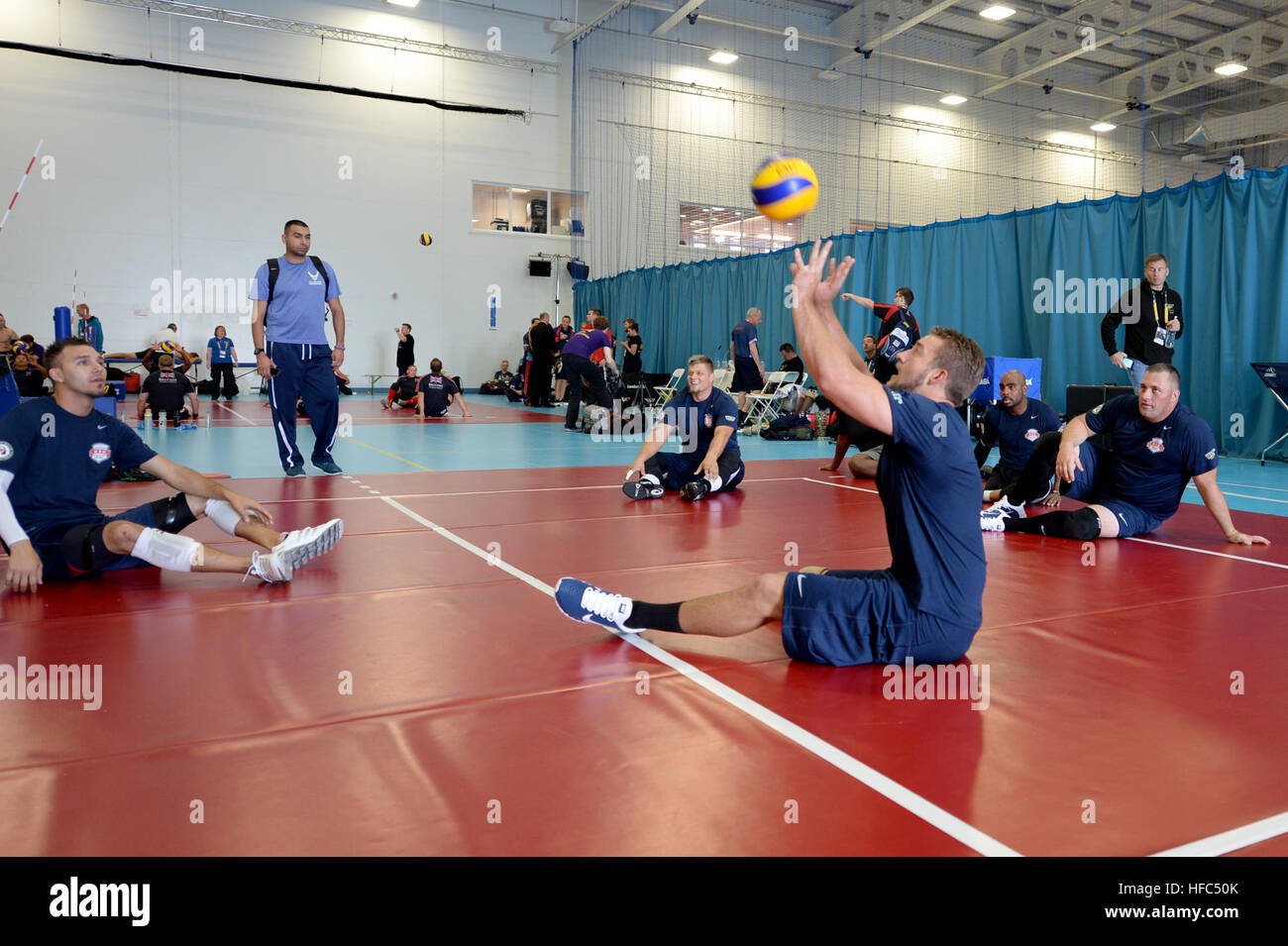Members of the U.S. seated volleyball team practice before the start of ...