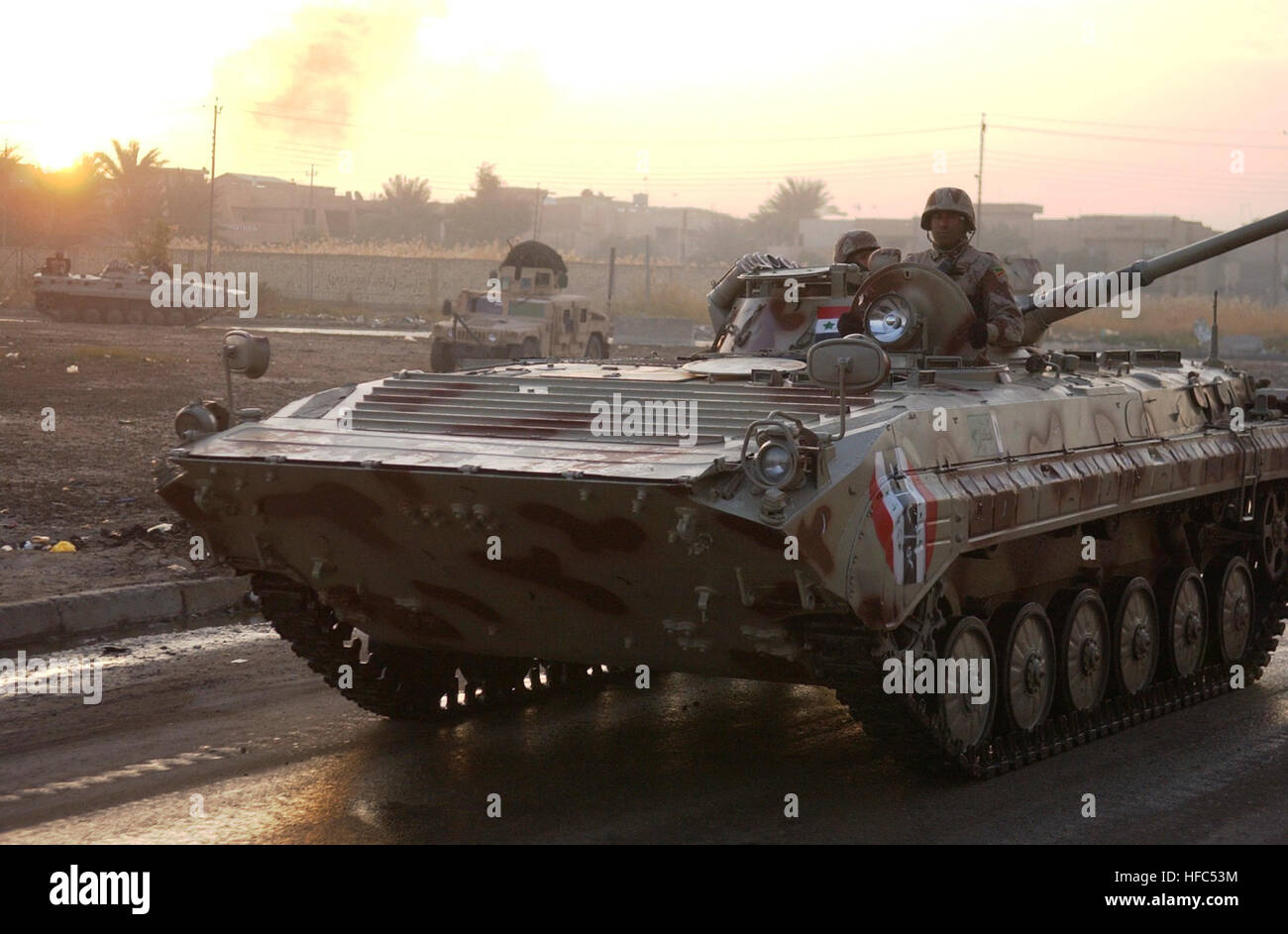 An Iraqi Army tracked vehicle patrols the streets as U.S. and Iraqi ...