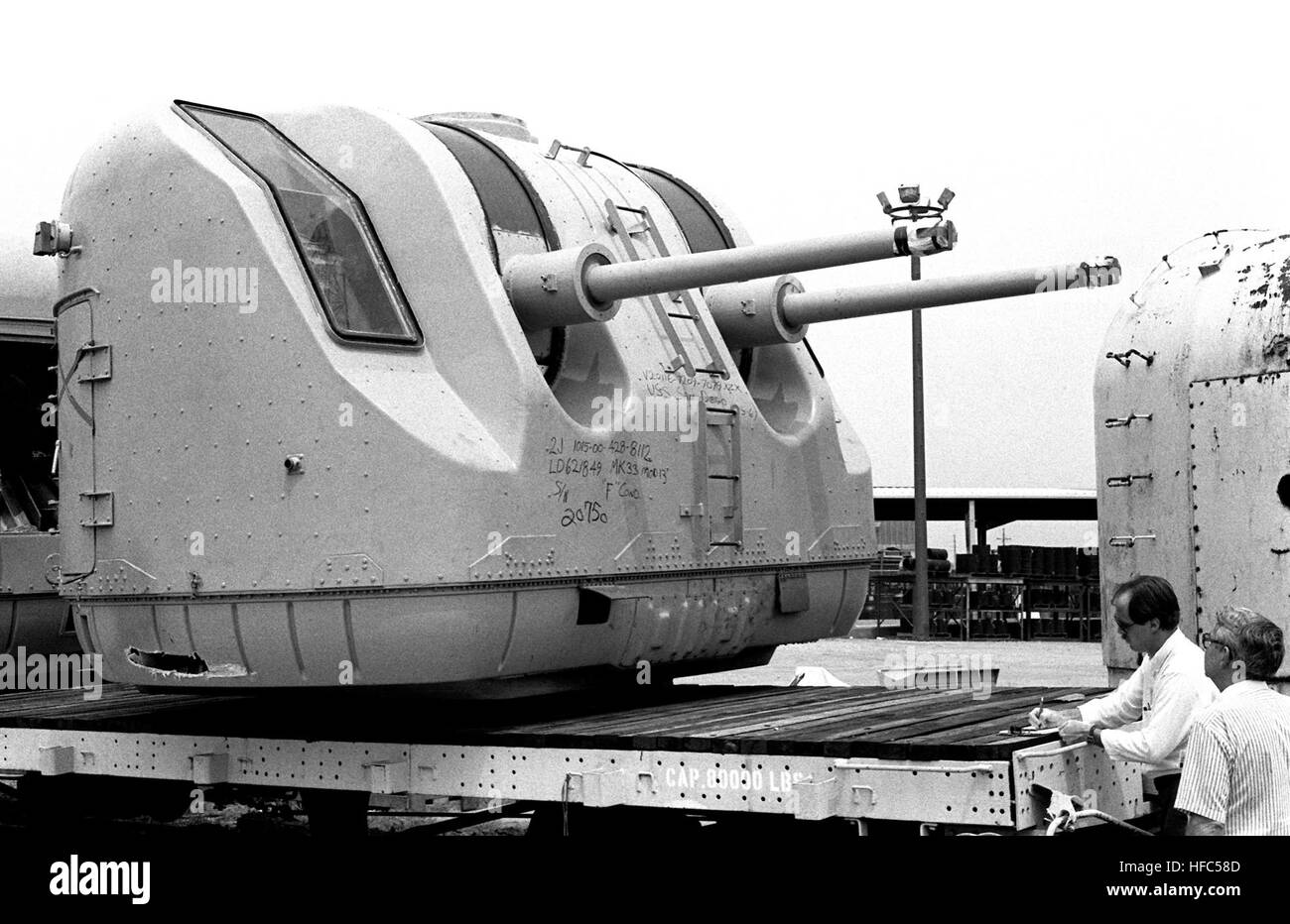 A Mark 33 Mod 13 3-inch/50-caliber gun mount sits on a flatbed railroad ...