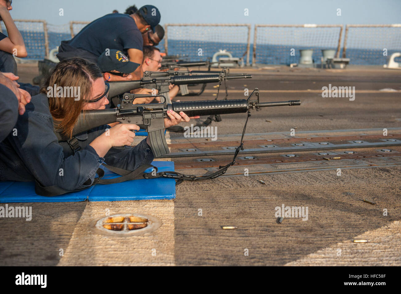 U.S. Sailors qualify using an M16 service rifle aboard the guided ...