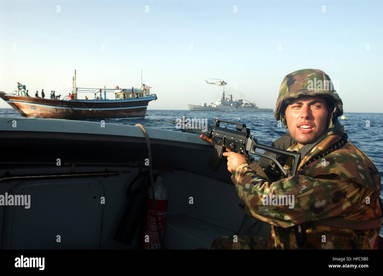 Onboard a patrol boat, an Italian Marine with a Beretta 5.56 mm SC70/90 ...