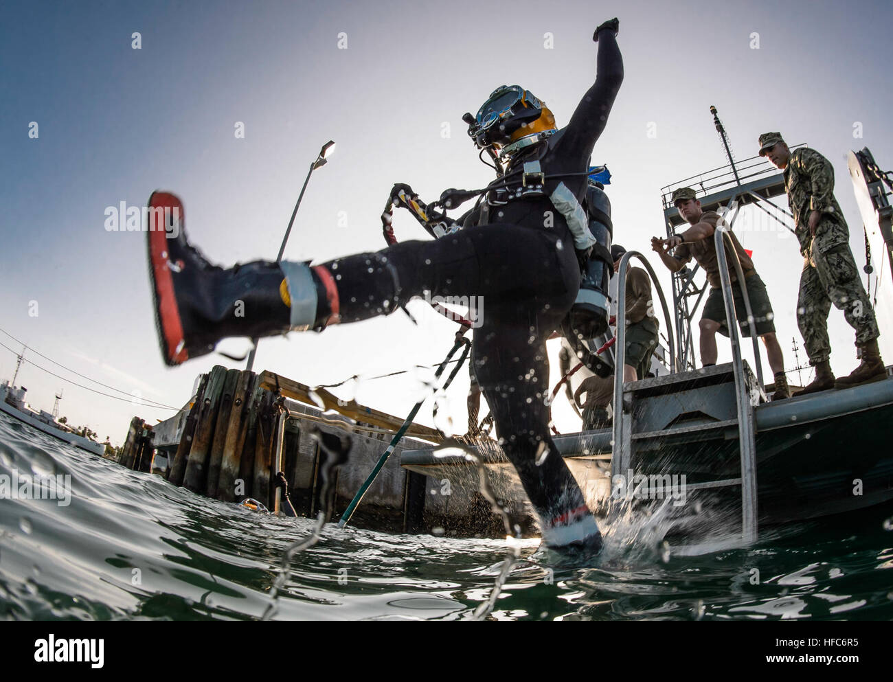 A Seabee diver conducts front-step water entry during joint training ...