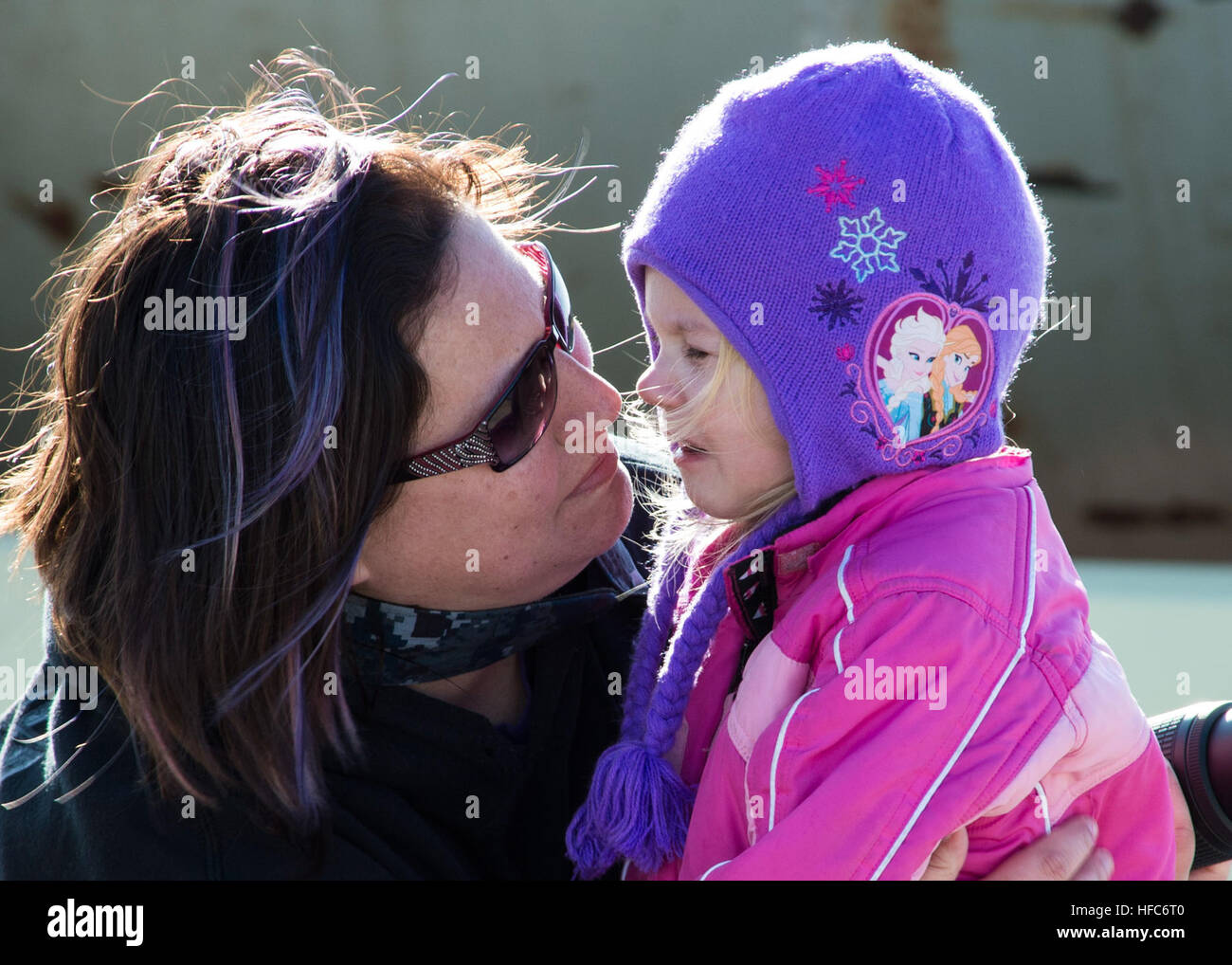 Jennifer Arce comforts a child as U.S. Navy Fire Controlman 1st Class ...