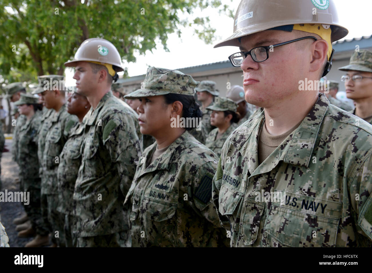 Sailors assigned to Naval Mobile Construction Battalion (NMCB) 11 stand ...