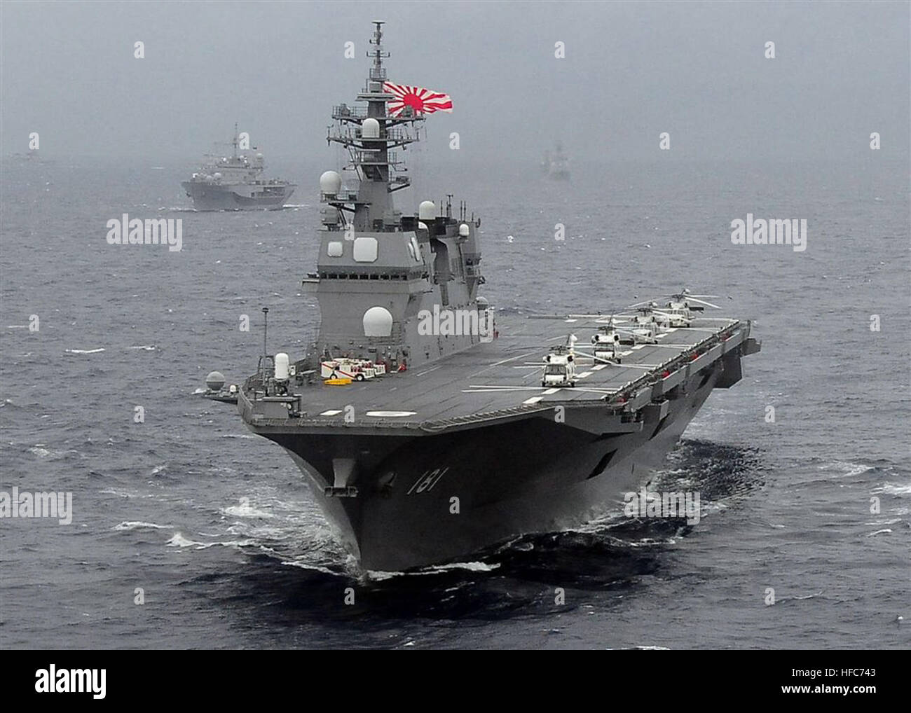 PACIFIC OCEAN (Nov. 17, 2009) – JS Hyuga (DDH 181) steams in front of a ...