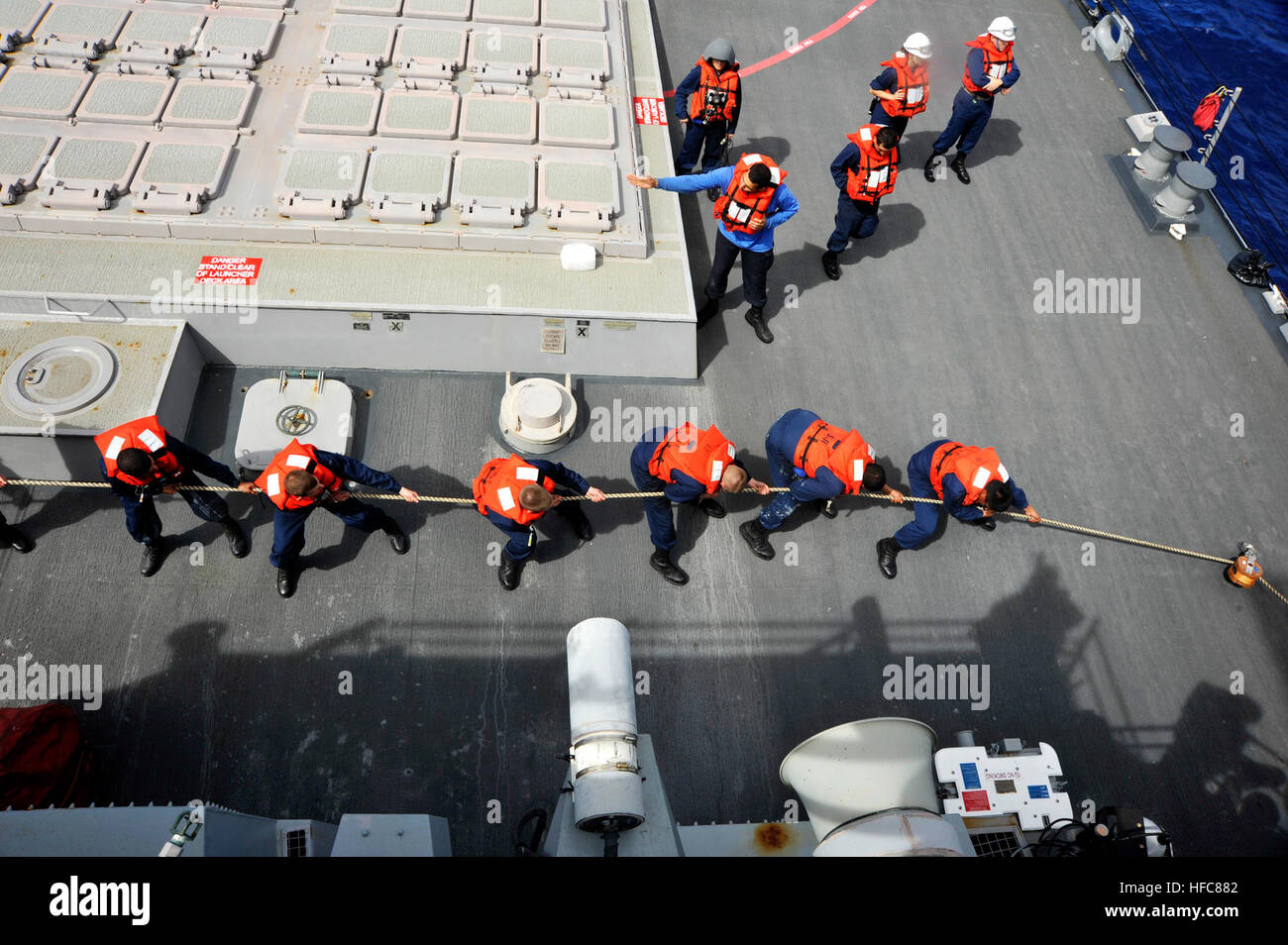 Sailors aboard guided-missile destroyer USS Halsey (DDG 97) handle a ...