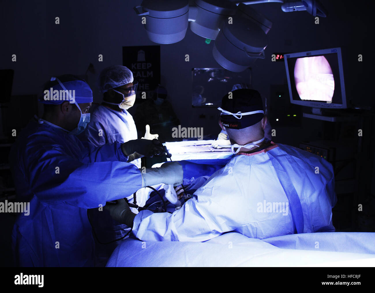 HM3 Najii Thomas assists Lt. Cmdr. Jack Brandau, a general surgeon, in ...