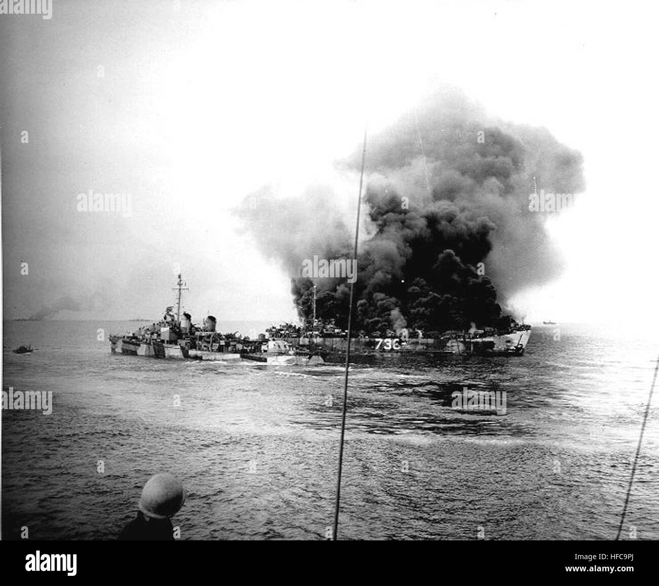 Landing Ship Tank LST-738 and destroyer USS Moale (DD-693) positioned ...