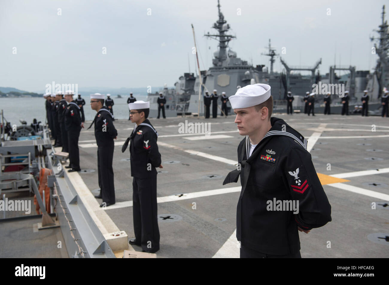 Sailors man the rails on the flight deck of Austin-class amphibious ...