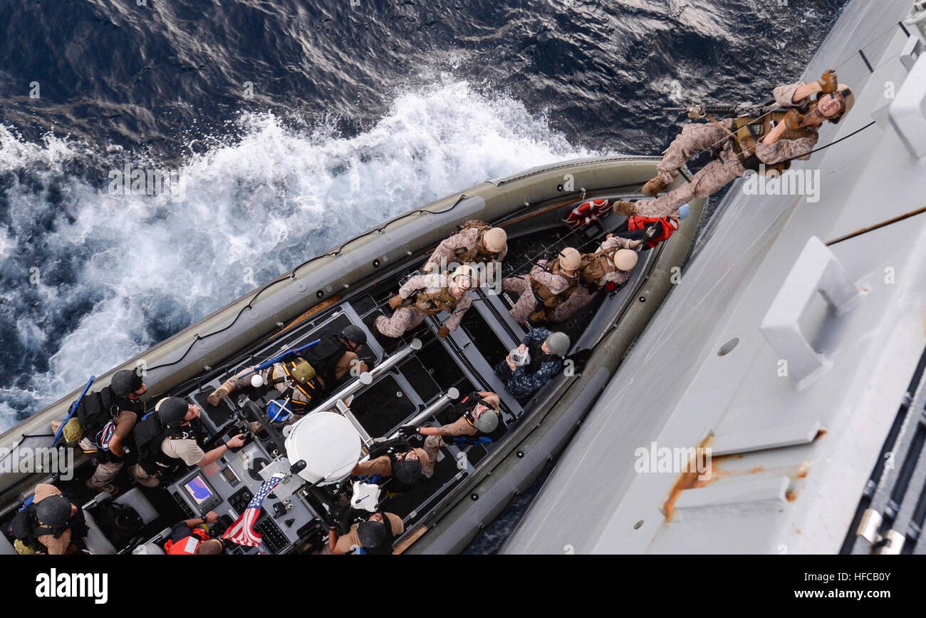 A Marine assigned to 11th Marine Expeditionary Unit climbs a Jacob's ...