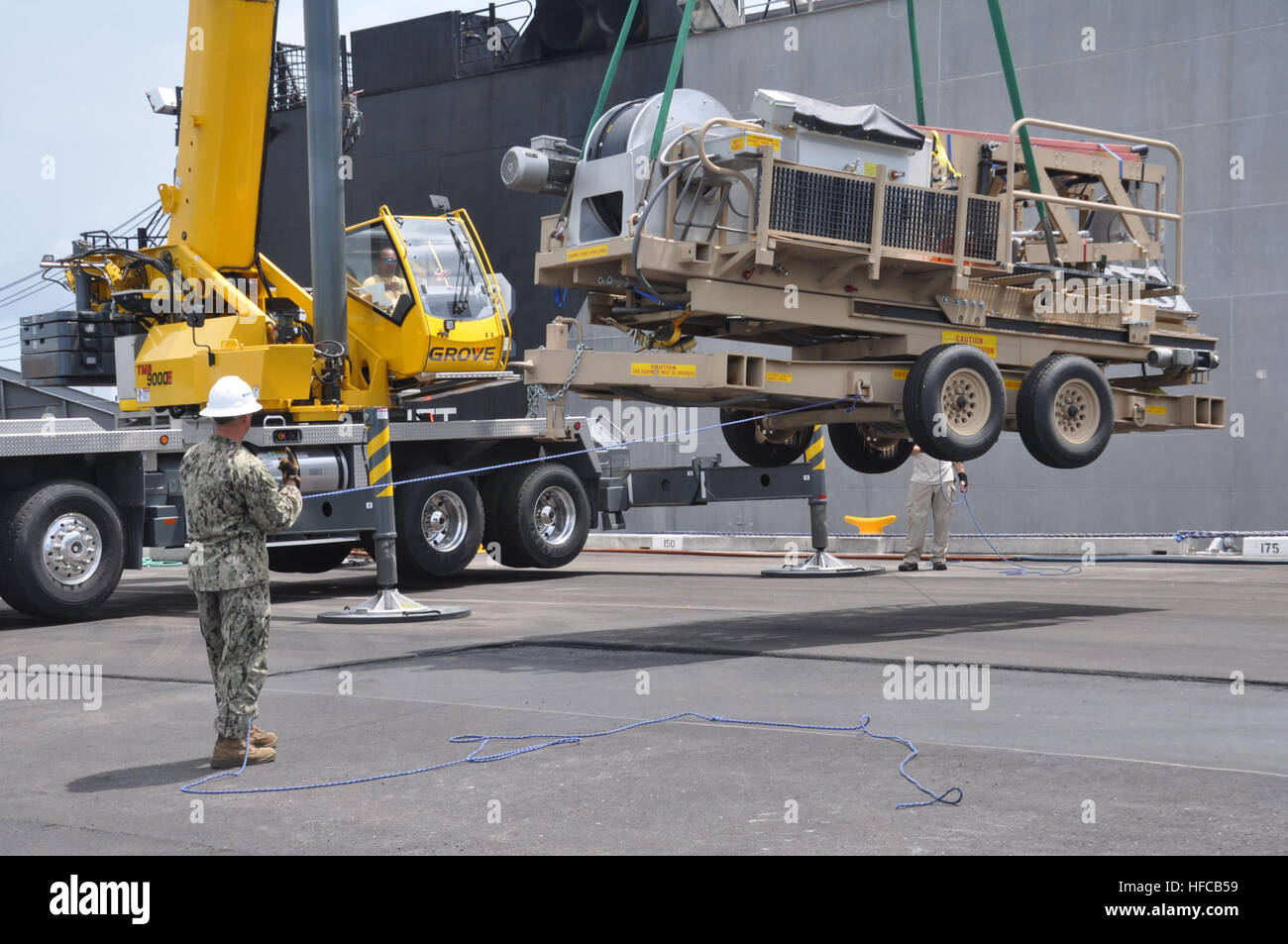 A crane lifts tethering apparatus for the TIF-25K aerostat system ...