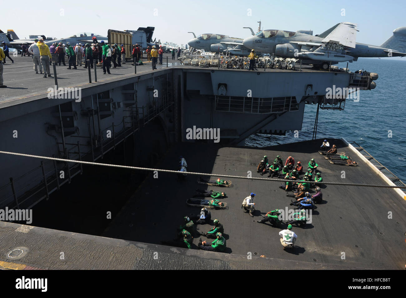 Sailors are taken below decks on an aircraft elevator for medical ...
