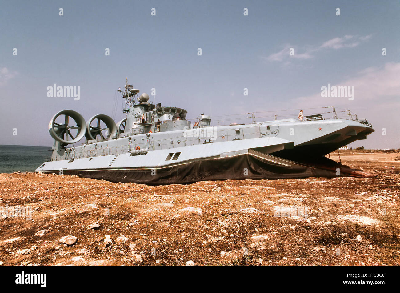 A Sailor stands on the bow of a beached Soviet Pomornik class air ...