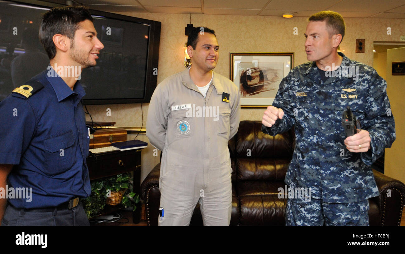 Rear Adm. Patrick Driscoll, commander of Carrier Strike Group 10, chats ...