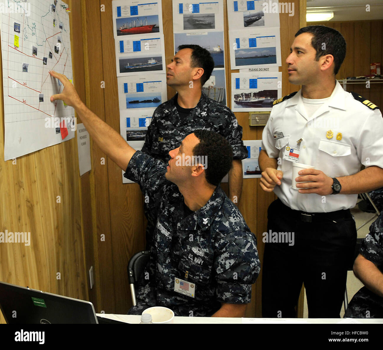 U.S. Navy Operations Specialist 1st Class Gavin Hawthorne points at a ...
