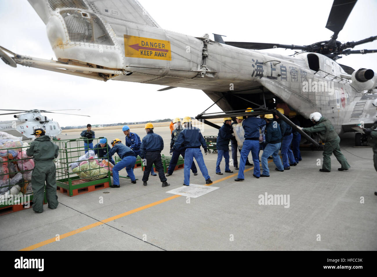 JMSDF Fleet Air Wing II personnel load humanitarian aid supplies onto ...