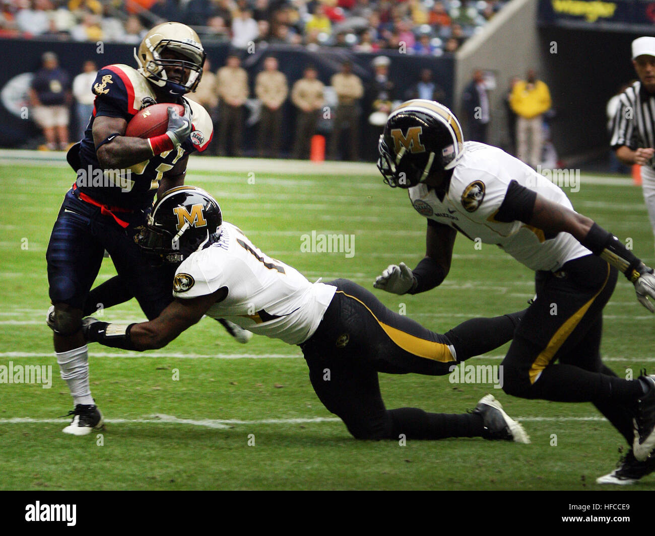 A U.S. Naval Academy football player carries the football during the ...