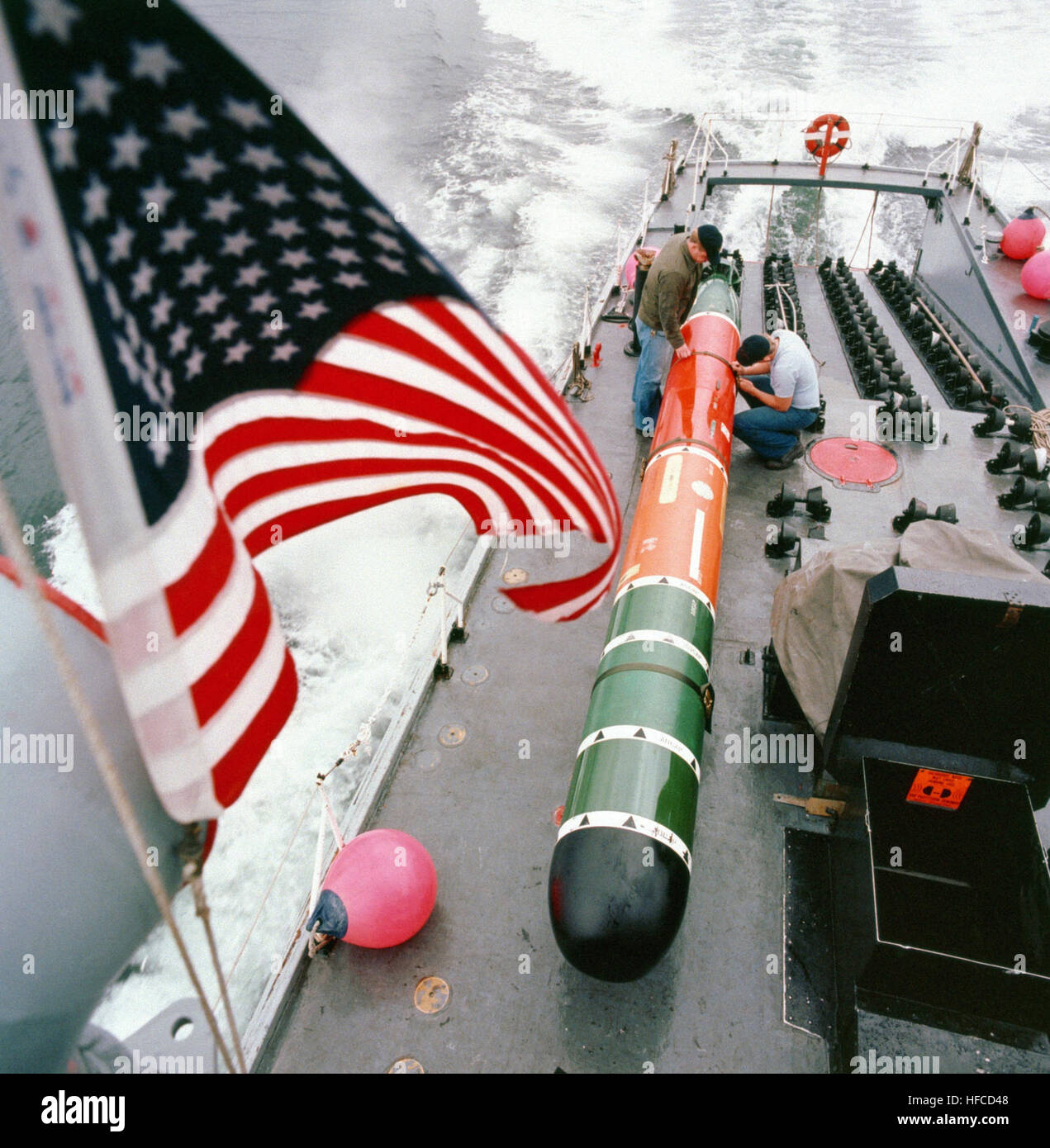 Crewmen aboard a Mk-2 72-foot torpedo retriever boat secure a Mk-48 ...