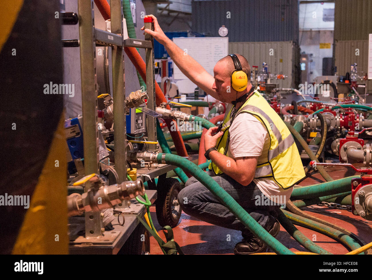 James Lance, waste handler for Parsons, monitors flow through a hose ...