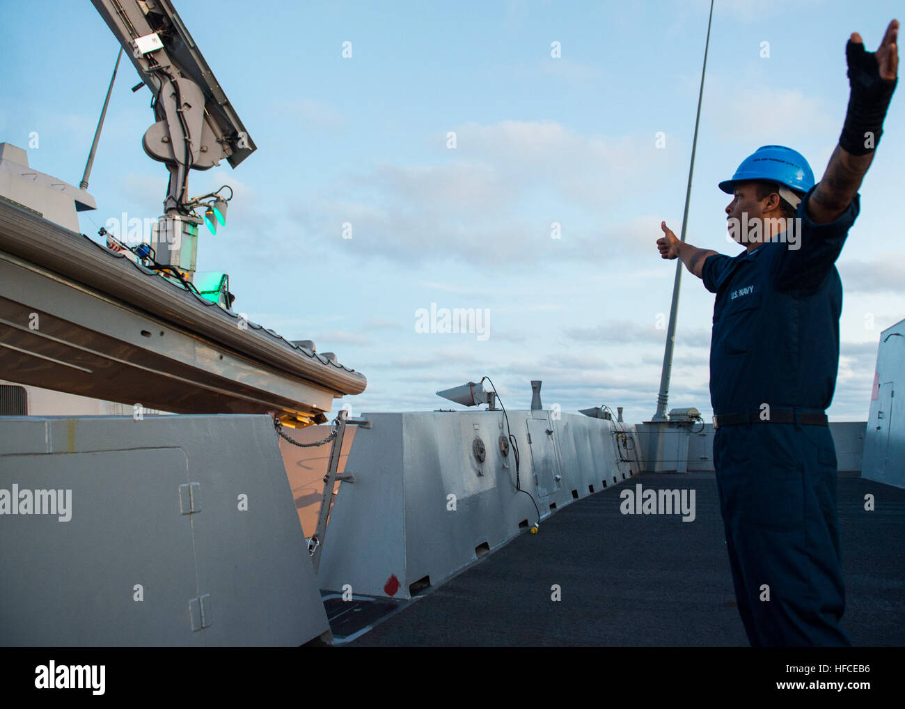 Boatswain’s Mate 3rd Class Troy Owens, signalman, directs a rigid hull ...