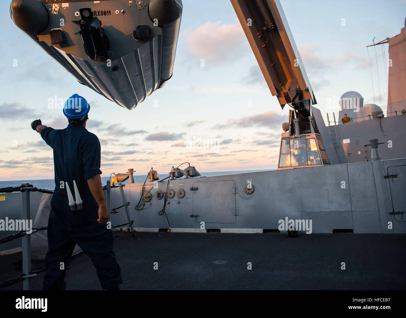 Boatswain’s Mate 3rd Class Troy Owens, signalman, directs a rigid hull ...