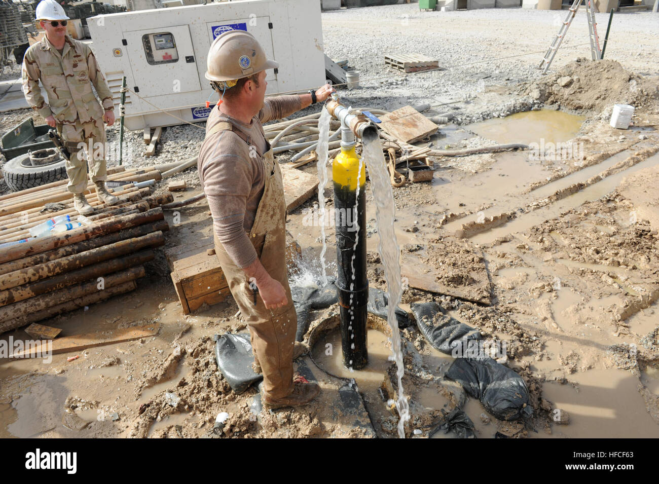 Equipment Operator 1st Class Jon M. Wawrek puts the final turn on the ...