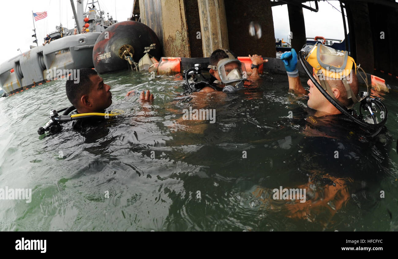 Petty Officer 2nd Class Jason Hatch briefs safety procedures to ...