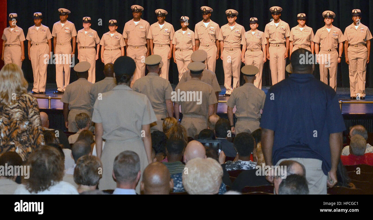 Fifteen newly-pinned Navy chiefs present themselves after receiving ...