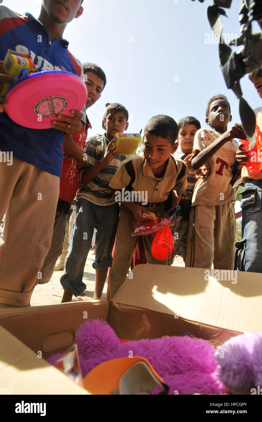 Iraqi children pick out toys during a humanitarian-aid operation ...