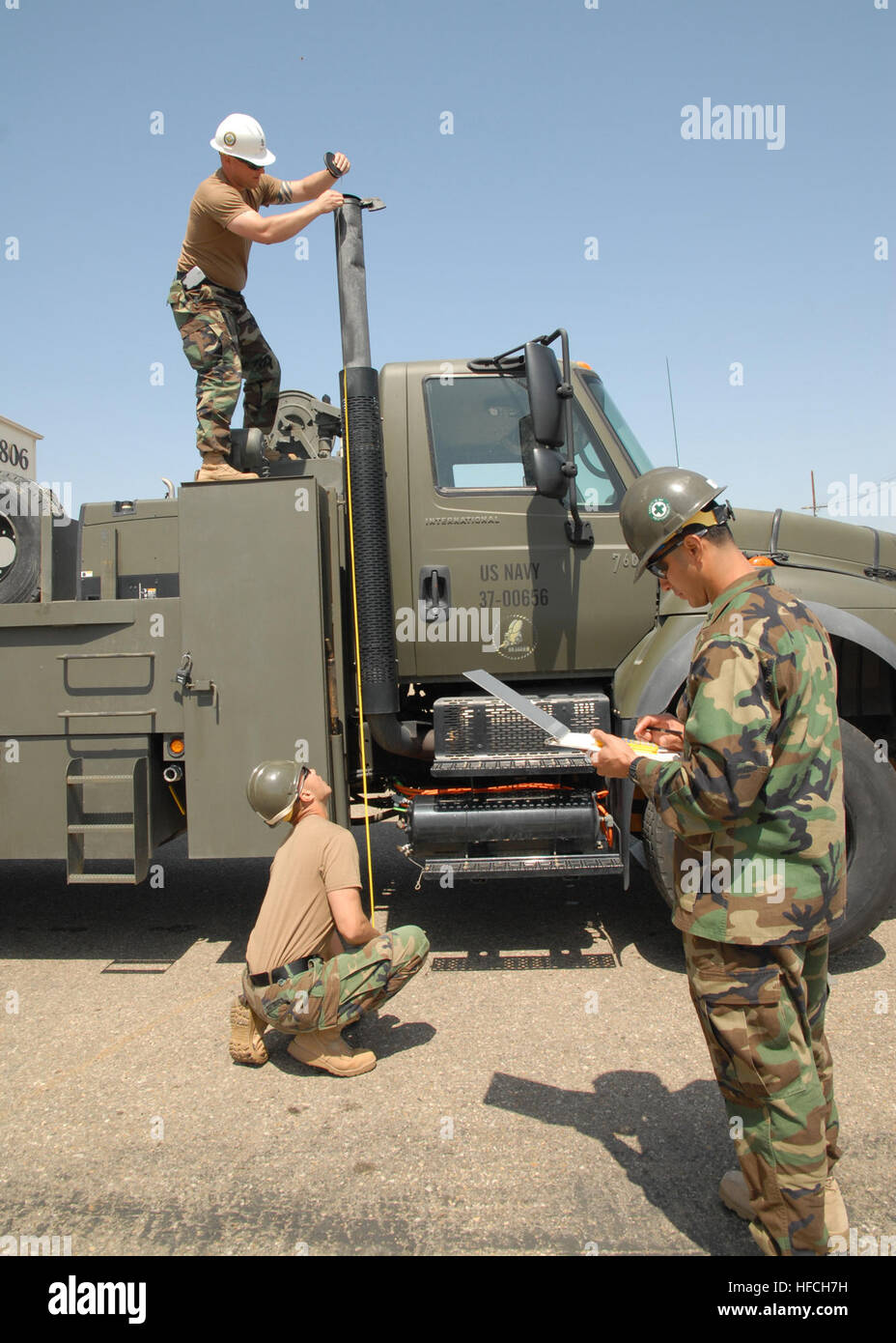 Seabees from Naval Mobile Construction Battalion (NMCB) 4 measure the ...