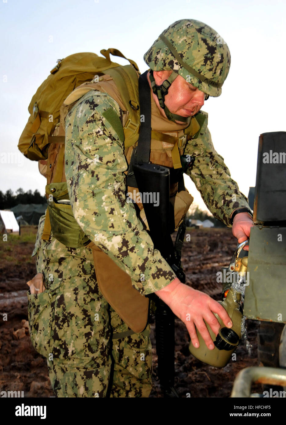 U.S. Navy Utilitiesman 1st Class Joseph McCarty fills his canteen with ...