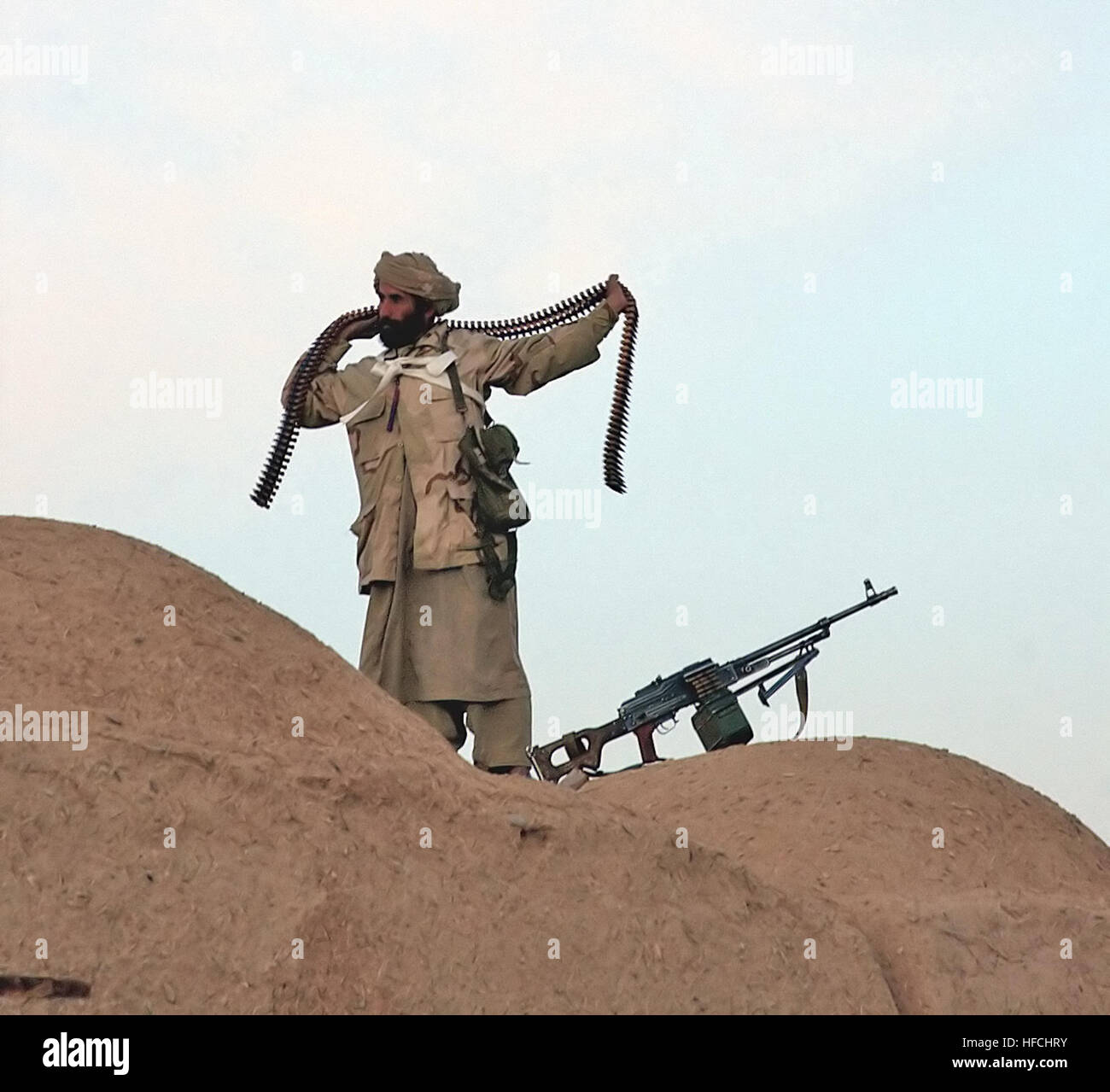 An Anti-Taliban Forces (ATF) fighter wraps a bandolier of ammunition ...