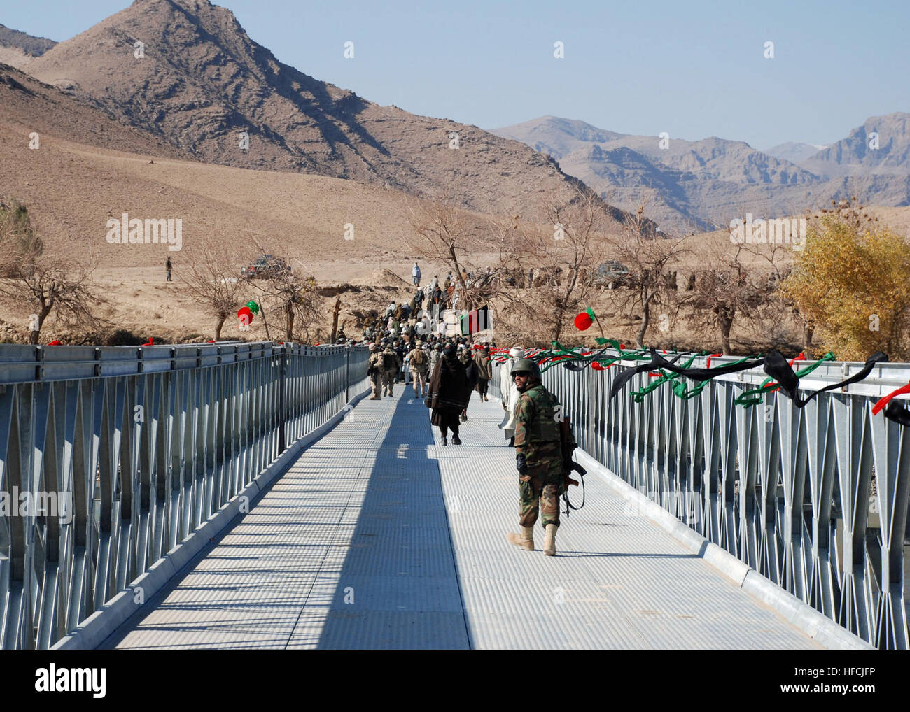 Members of the Afghan national army and local villagers cross the Chutu ...