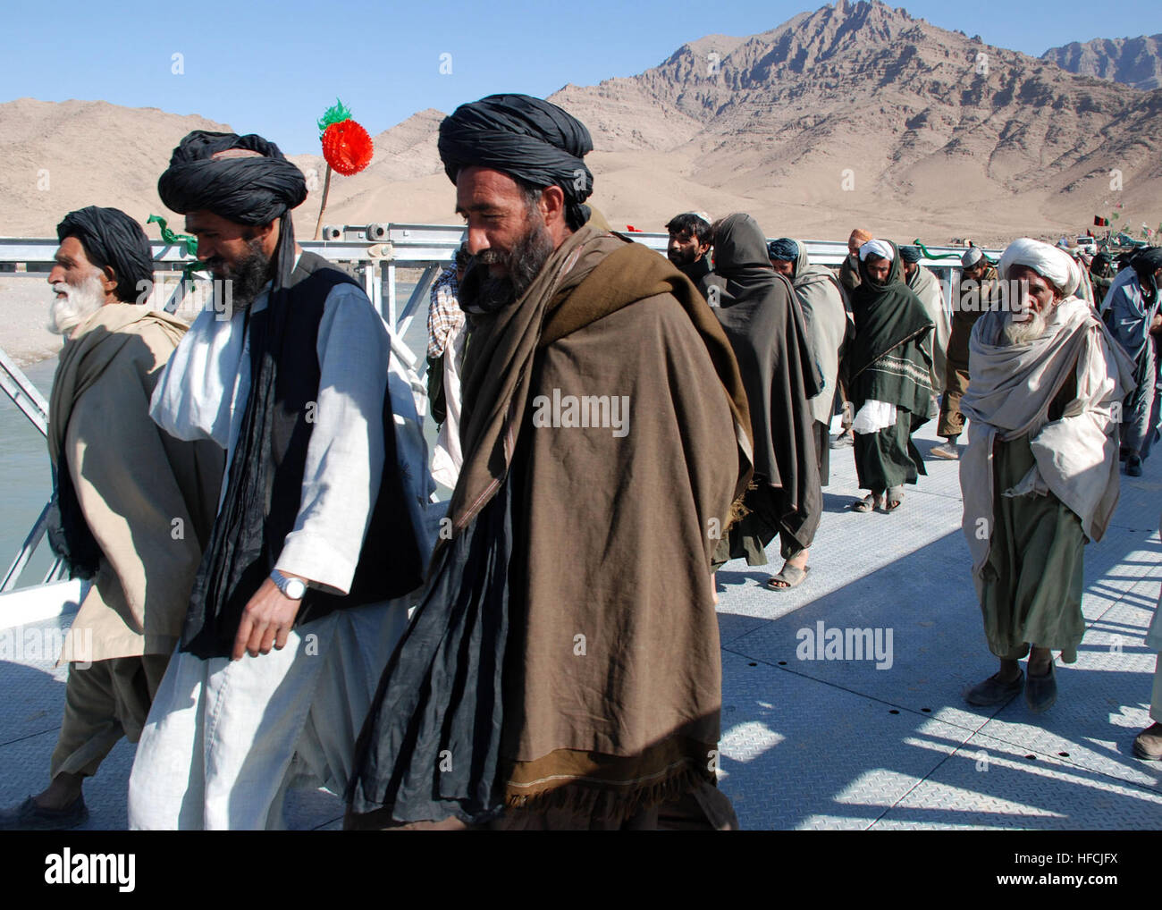 Villagers proudly walk across the Chutu Bridge to mark its official ...