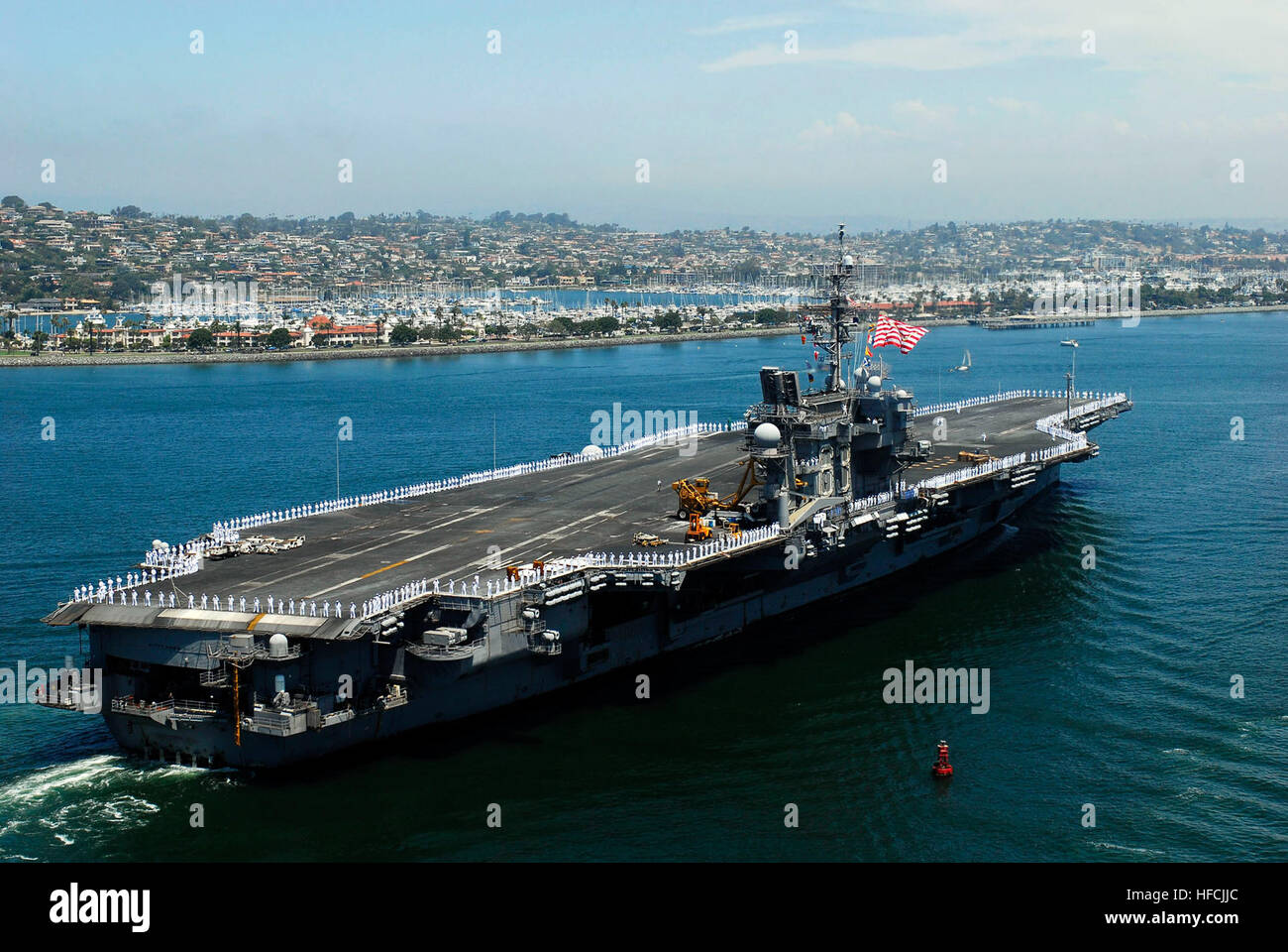 The aircraft carrier USS Kitty Hawk prepares to moor at Naval Air ...